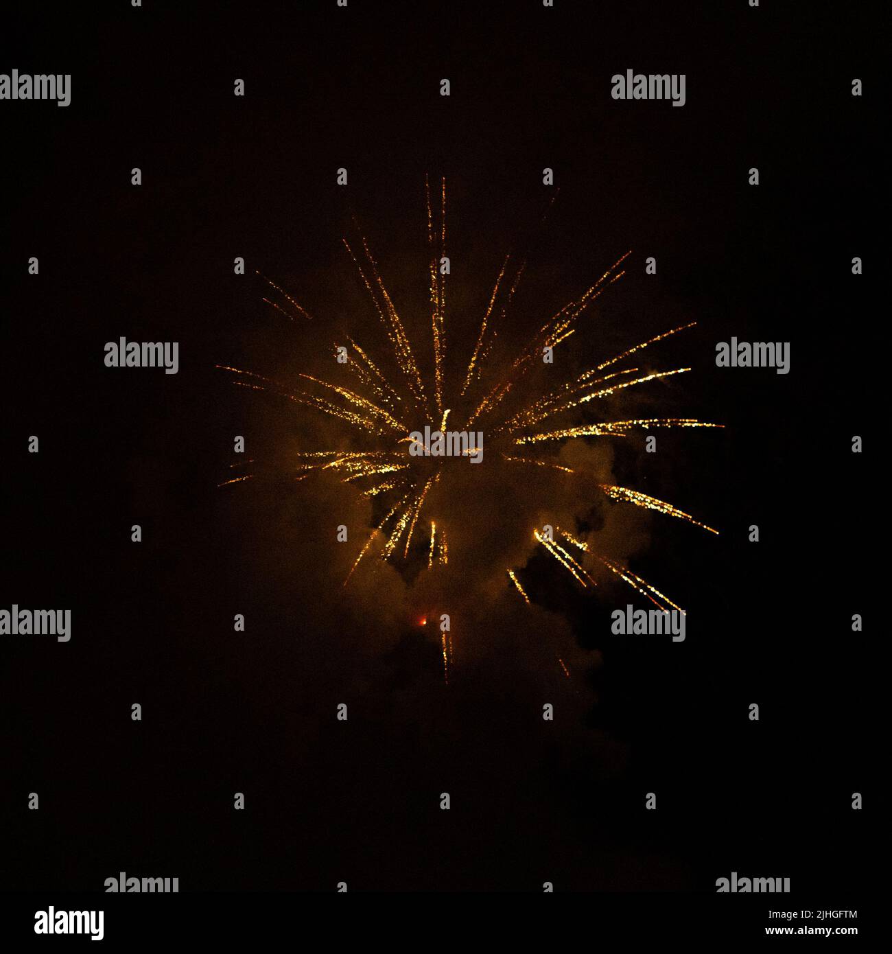 Bright fireworks with a sphere or circle shape exploding against black ...