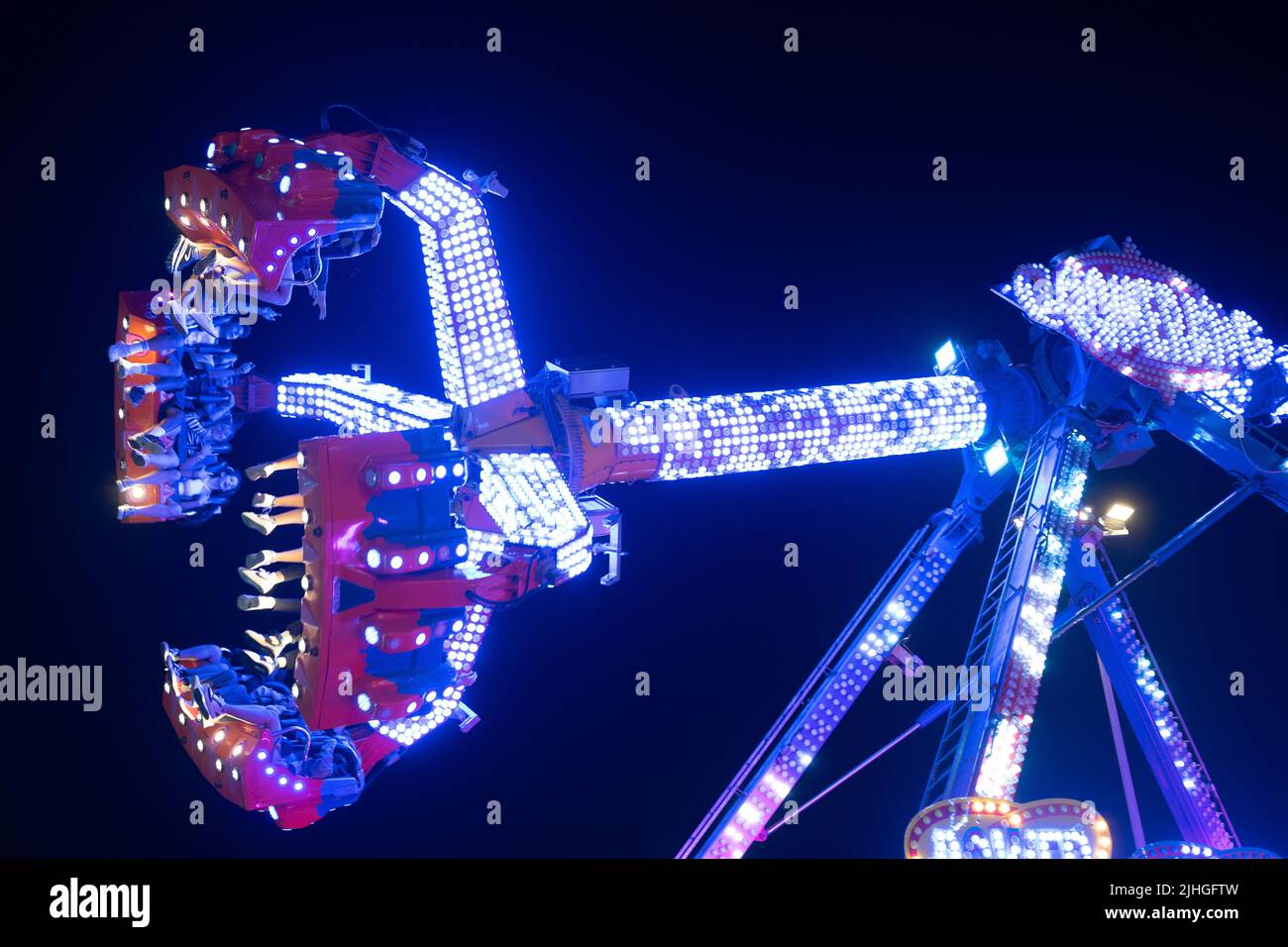 Amusement ride with bright lights against dark sky Stock Photo - Alamy