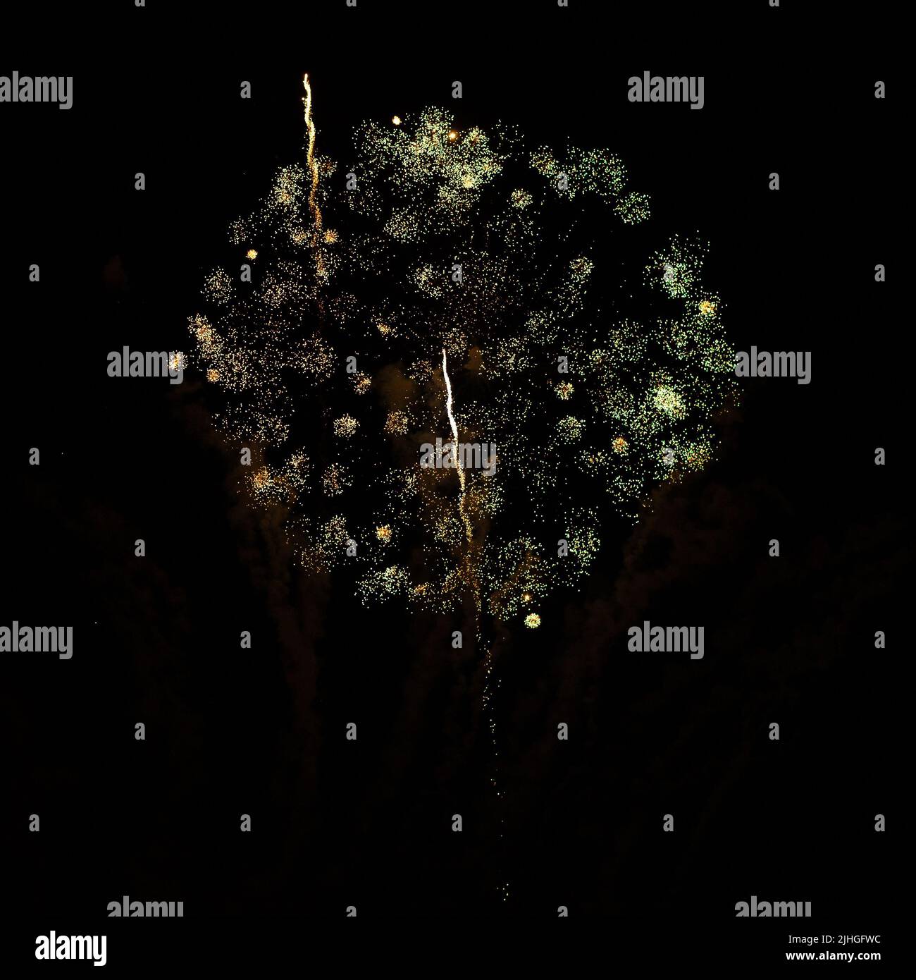 Bright fireworks with a sphere or circle shape exploding against black ...