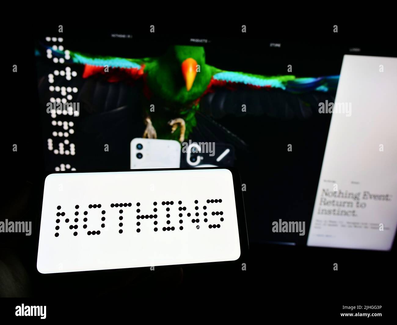 Person holding smartphone with logo of British company Nothing Technologies Limited on screen in ...