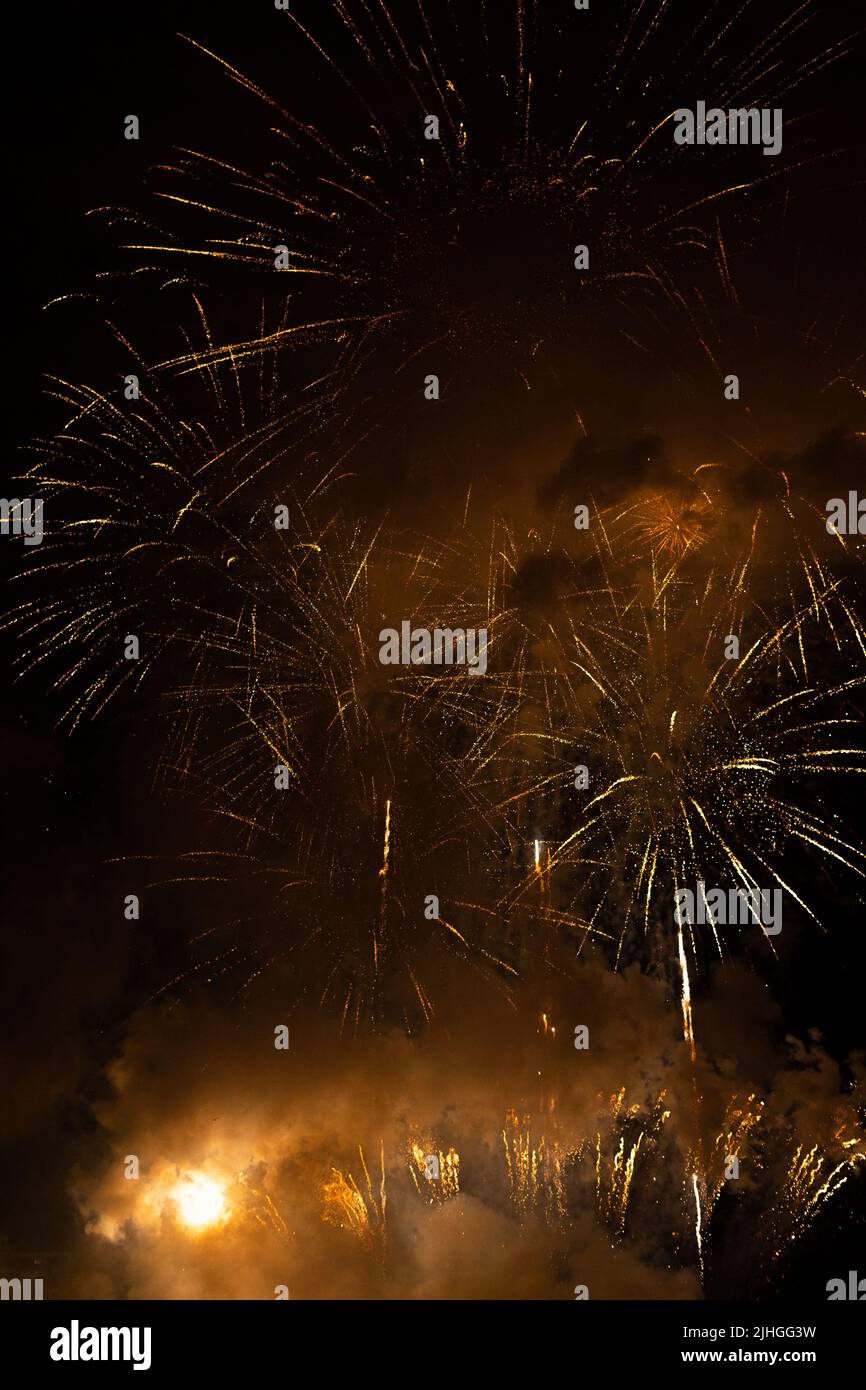 Fireworks exploding behind the smoke against black background Stock ...