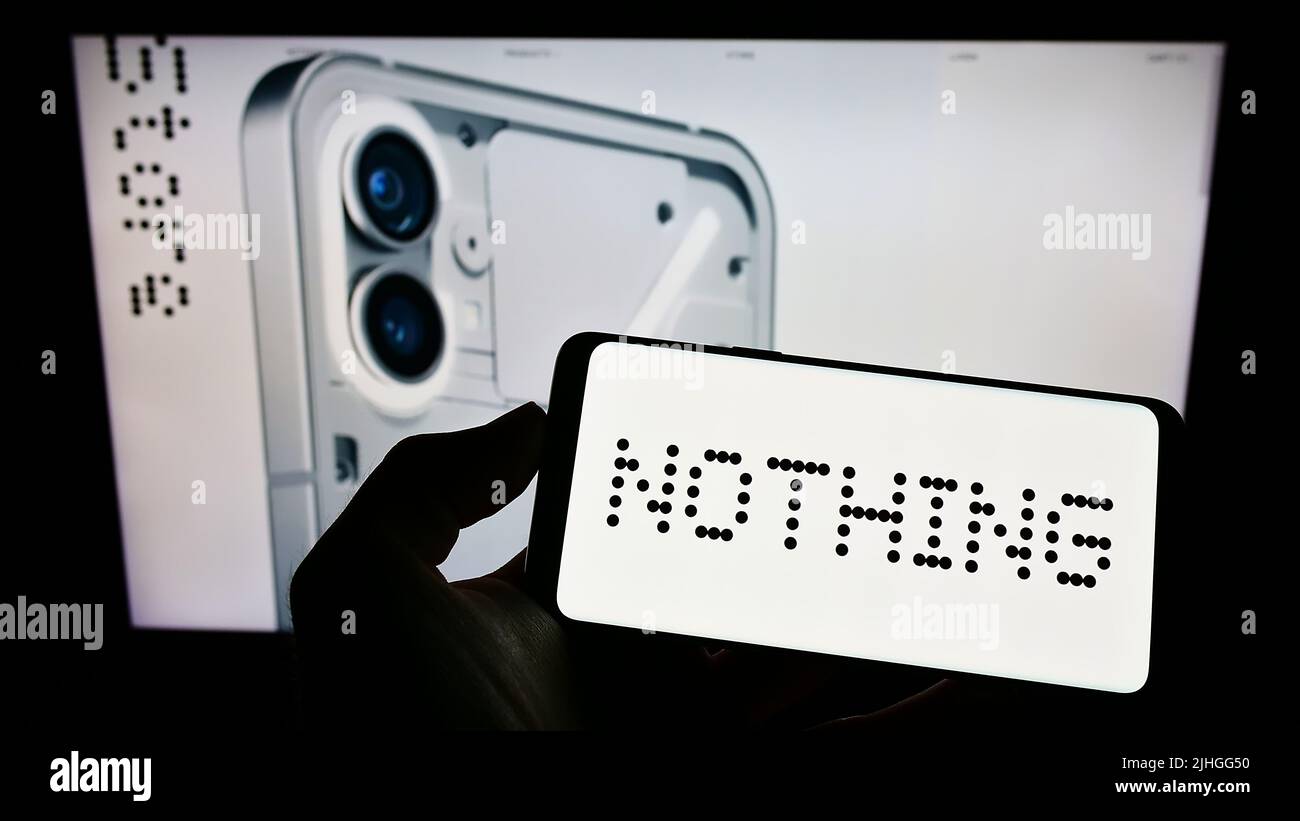 Person holding cellphone with logo of British company Nothing Technologies Limited on screen in ...