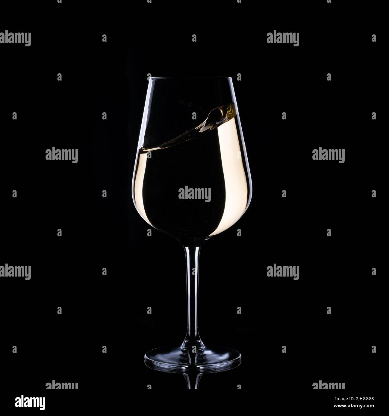 white wine splash in glass isolated on black background Stock Photo - Alamy