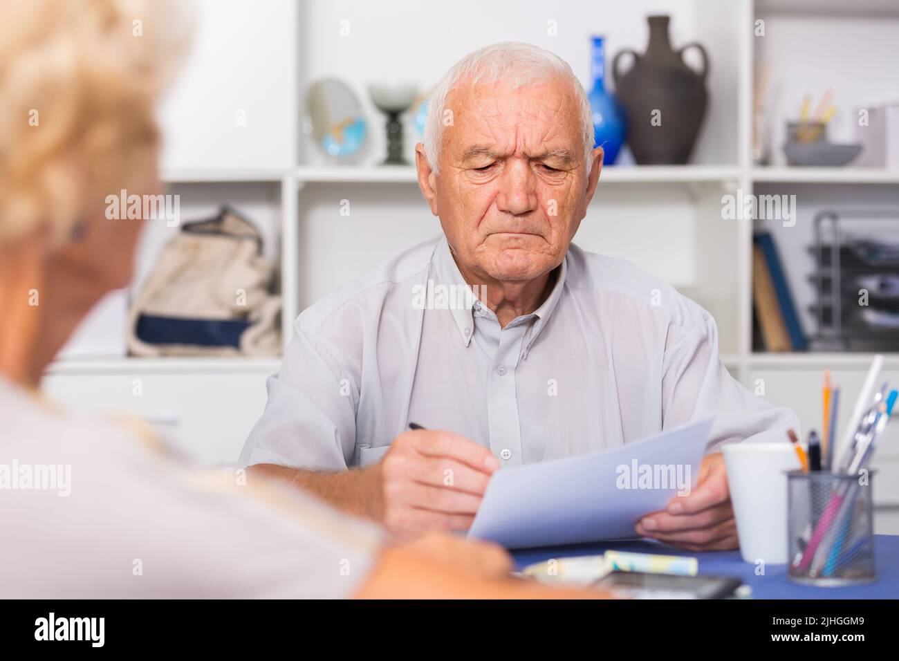 Upset senior man discussing with wife bills Stock Photo - Alamy