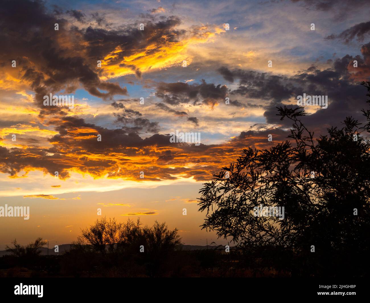 A beautiful peach and orange sunset precludes a massive summer storm ...