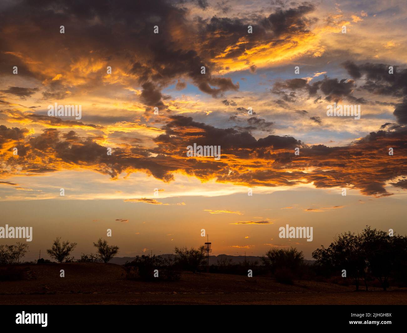 A beautiful peach and orange sunset precludes a massive summer storm ...
