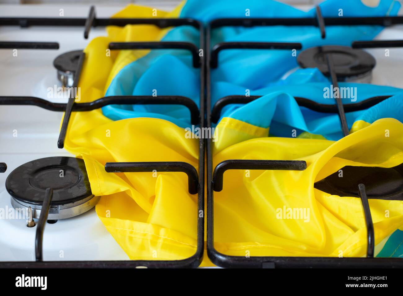 The Ukrainian flag lies on a gas stove in the kitchen in an apartment ...