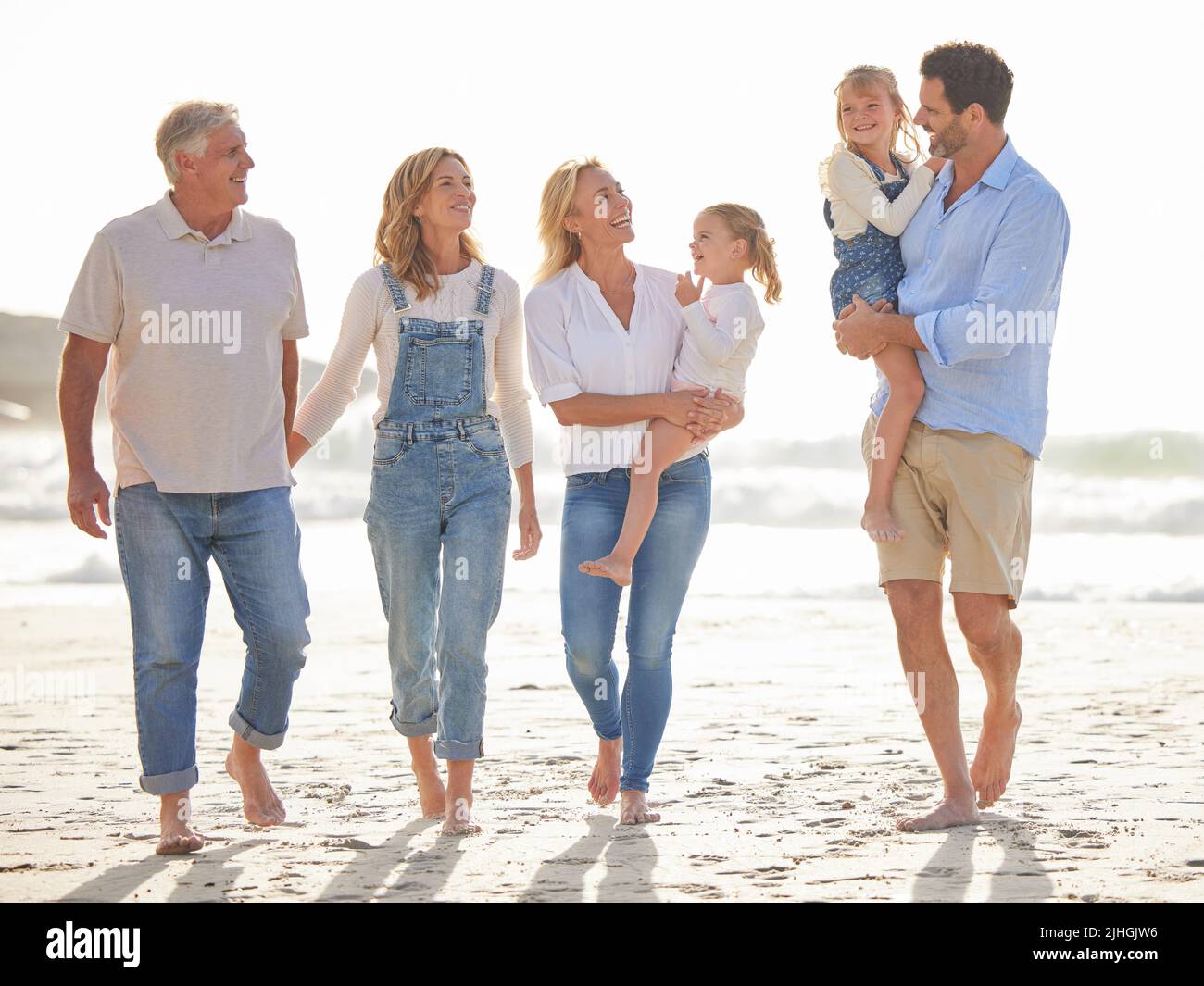 Parents two children walking holding hi-res stock photography and ...