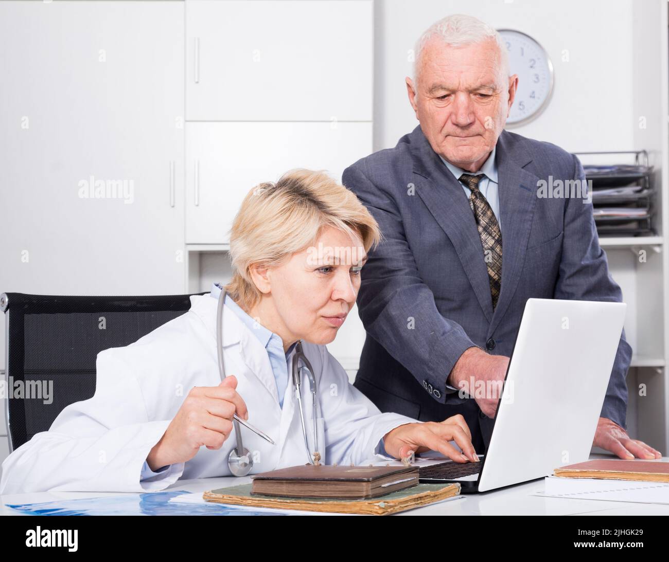 Female doctor with male client Stock Photo - Alamy
