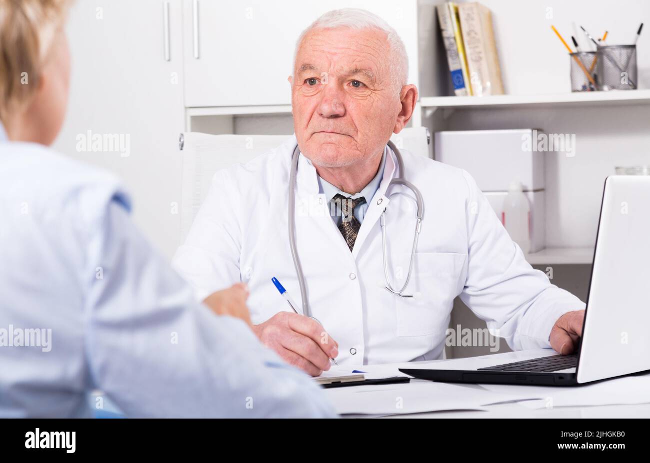 Male doctor with female client Stock Photo - Alamy