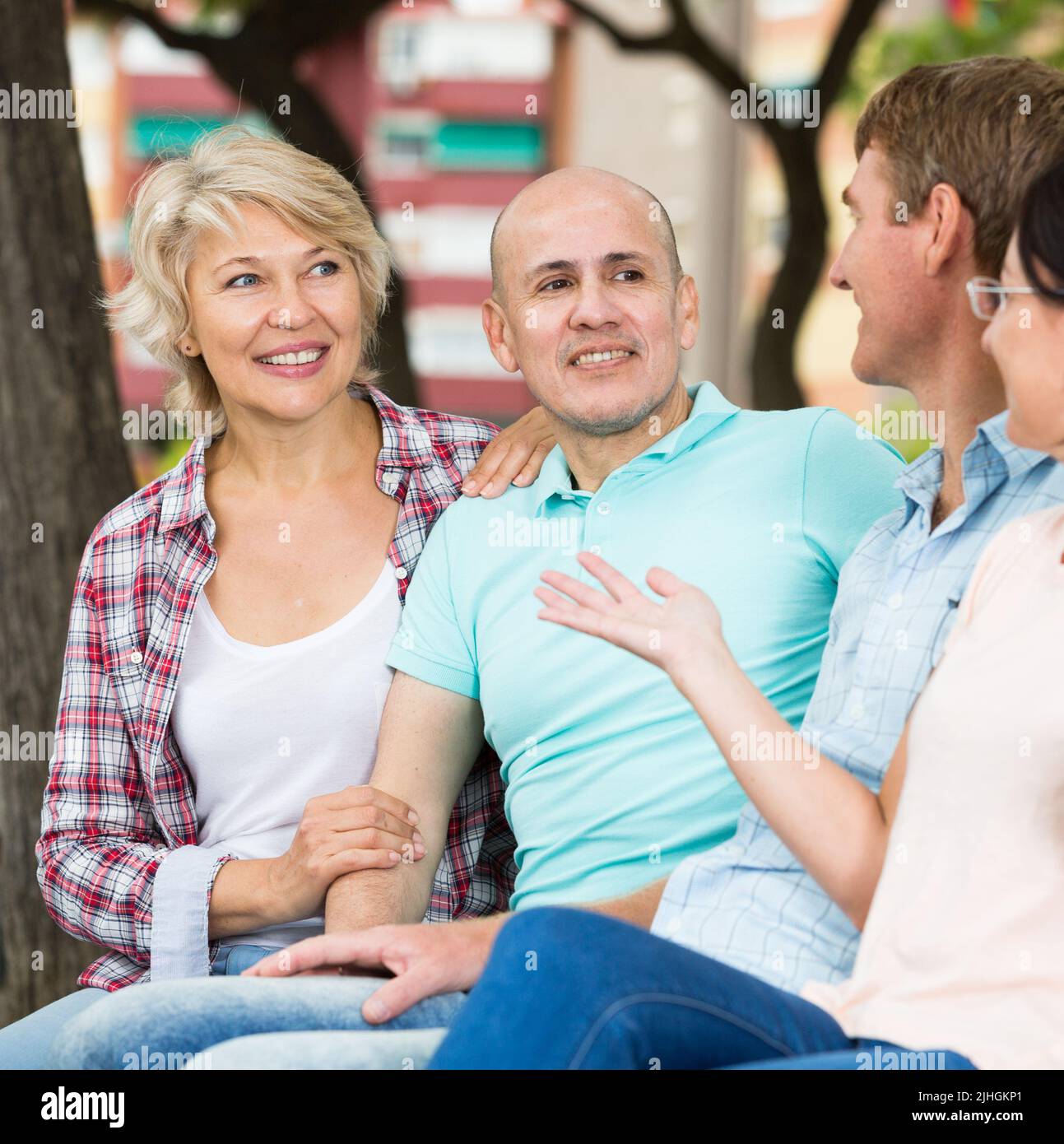 Smiling couples walking and talking Stock Photo - Alamy
