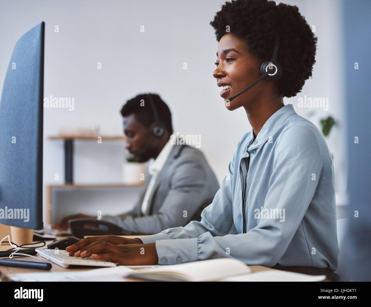 Happy young african american call centre telemarketing agent talking on ...