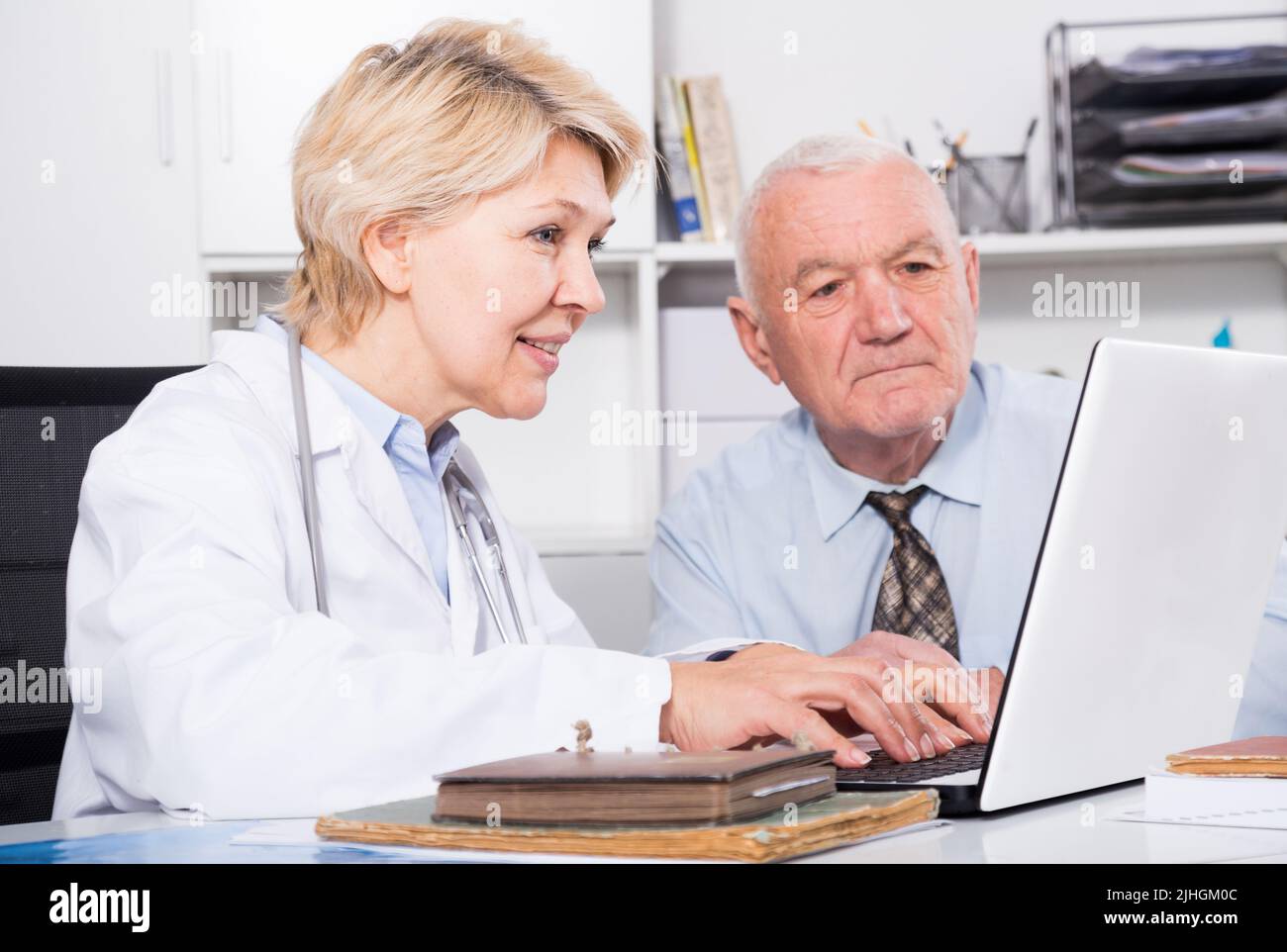 Female doctor with male client Stock Photo - Alamy