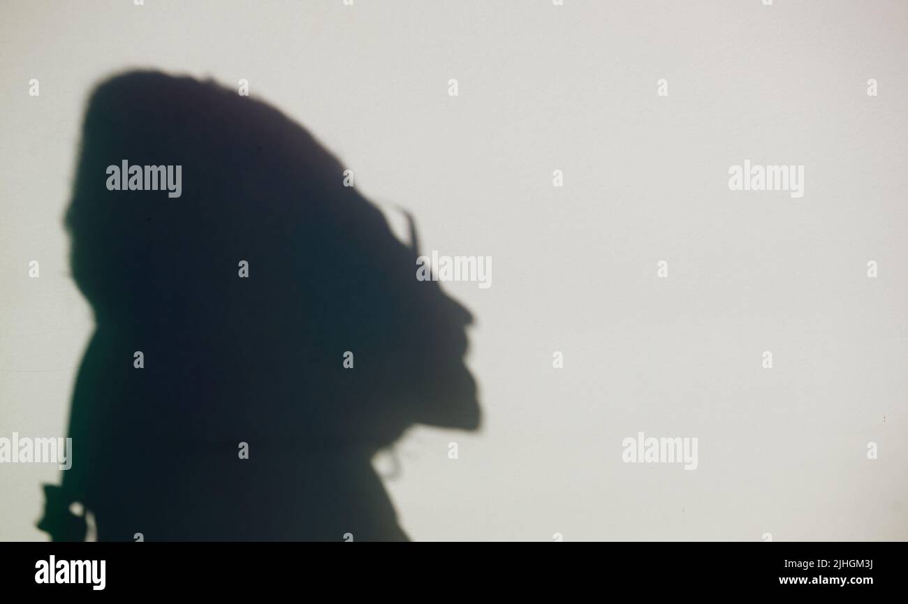 Silhouette of a woman face shadow on the wall - weird passage - white ...