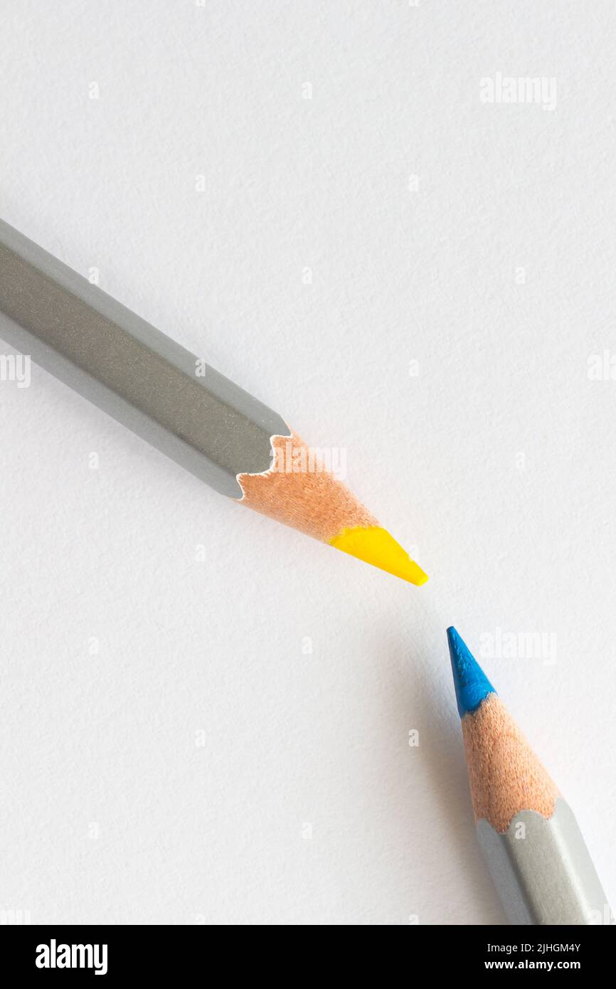 Blue and yellow pencils on a white background Stock Photo - Alamy