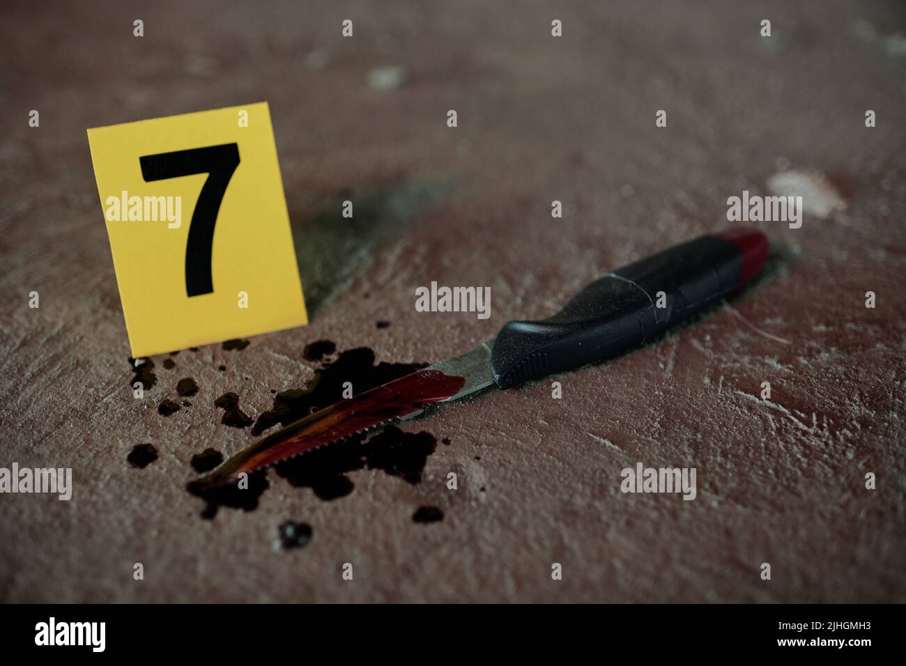 Close-up of knife representing murder weapon with stains of blood of ...