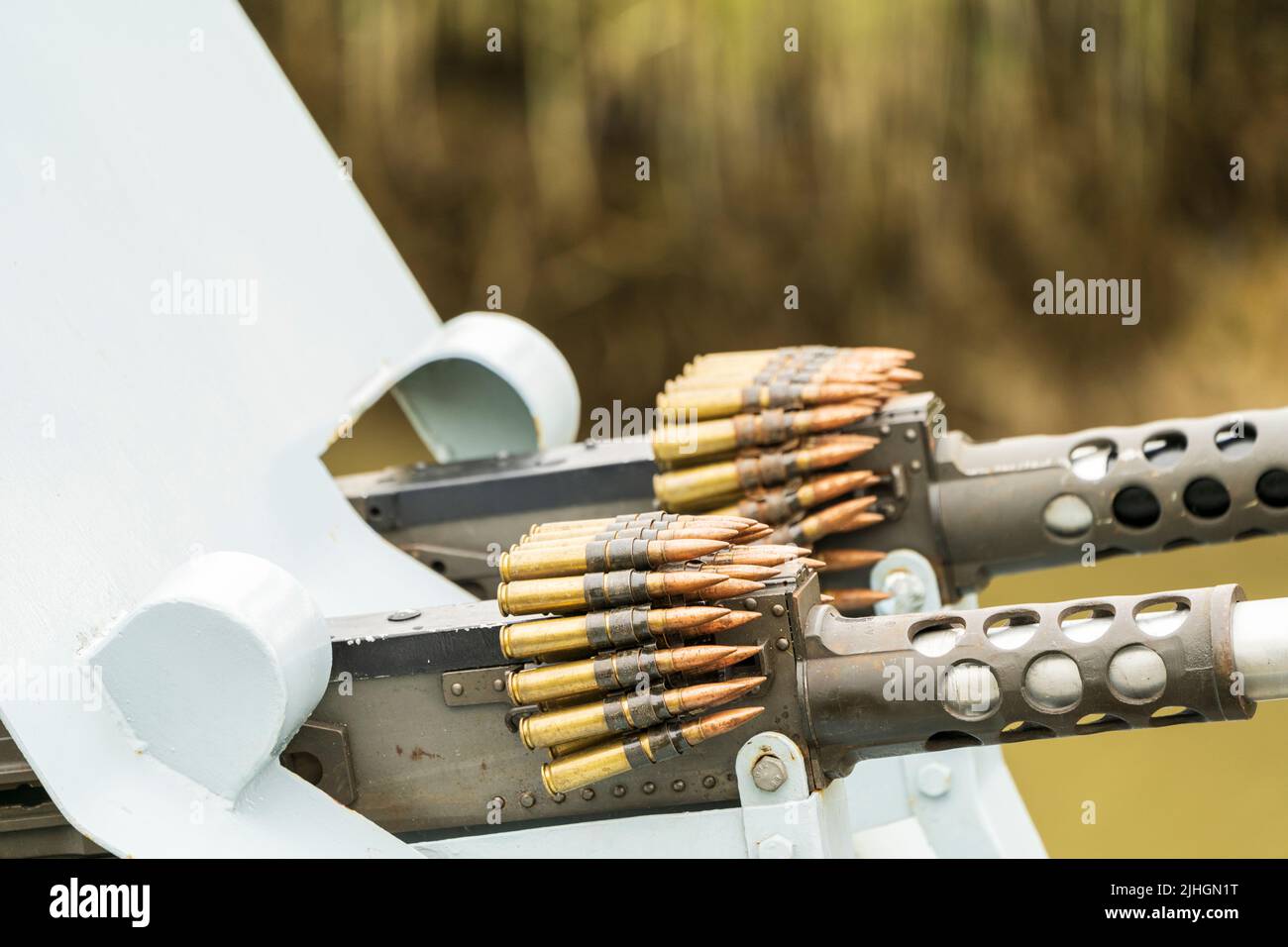 Cluster of 30 caliber ammunition, bullets, on top of double M1919 ...