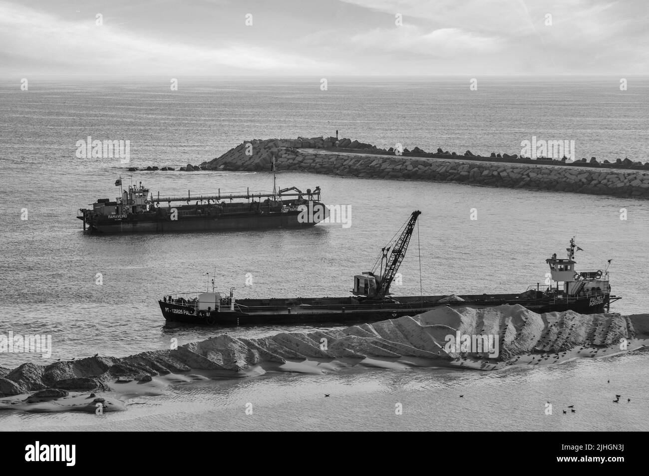 ships cleaning the sand on the bottom of a ocean port Stock Photo - Alamy