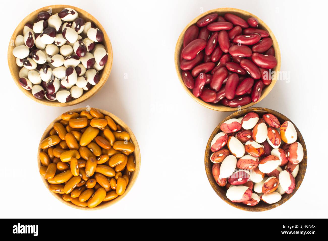Four kinds of beans on white background. Top view Stock Photo - Alamy