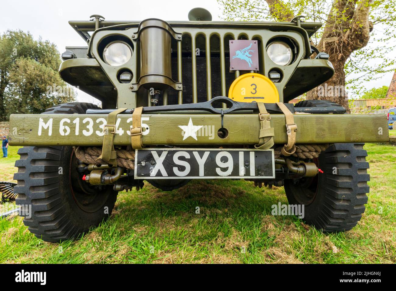 Close up low angle view of the front of an American army jeep from ...