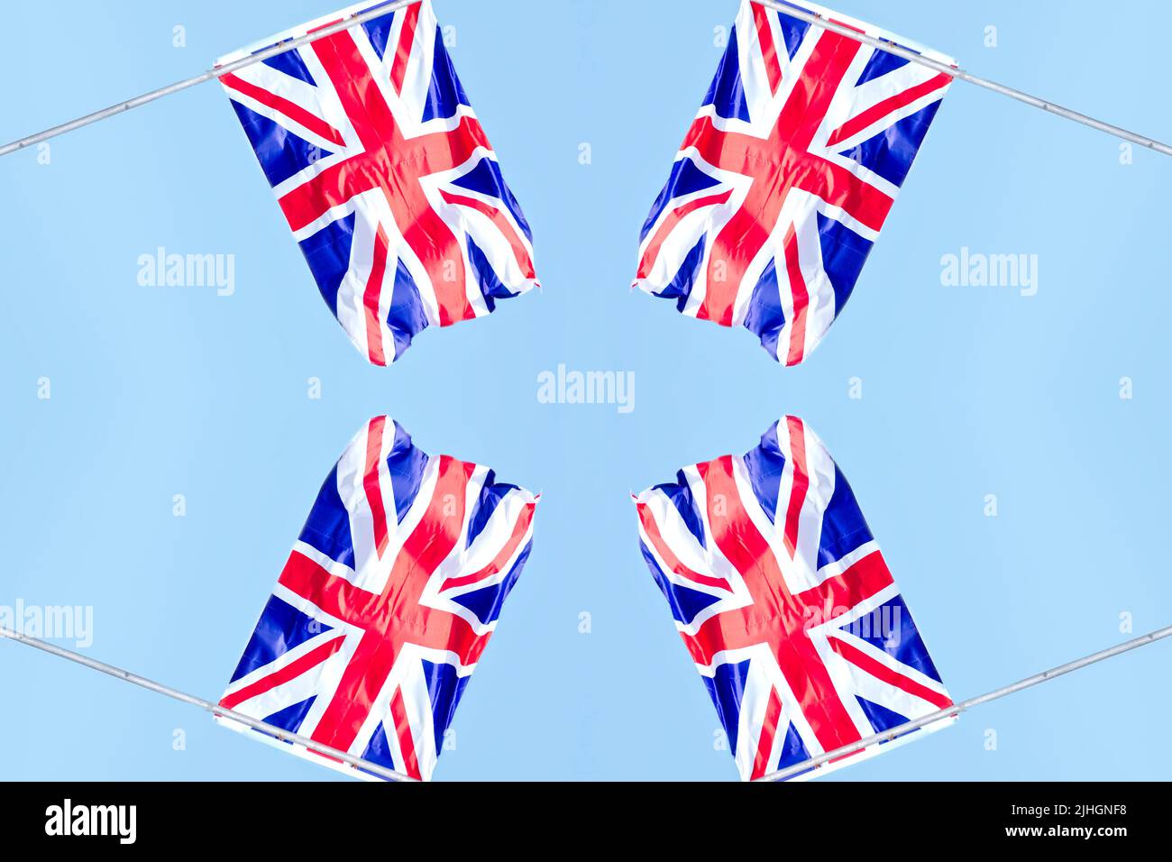 Union Jack flags suspended high in sky Stock Photo - Alamy