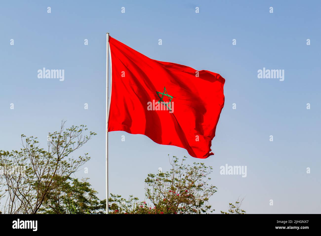 Isolated Moroccan flag with green star waving in a blue sky Stock Photo ...