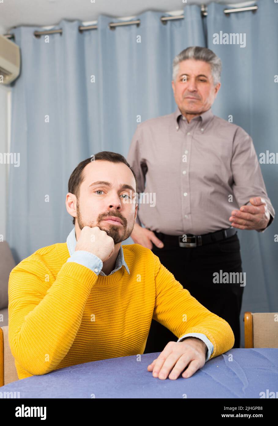 Adult father teaches his son Stock Photo - Alamy