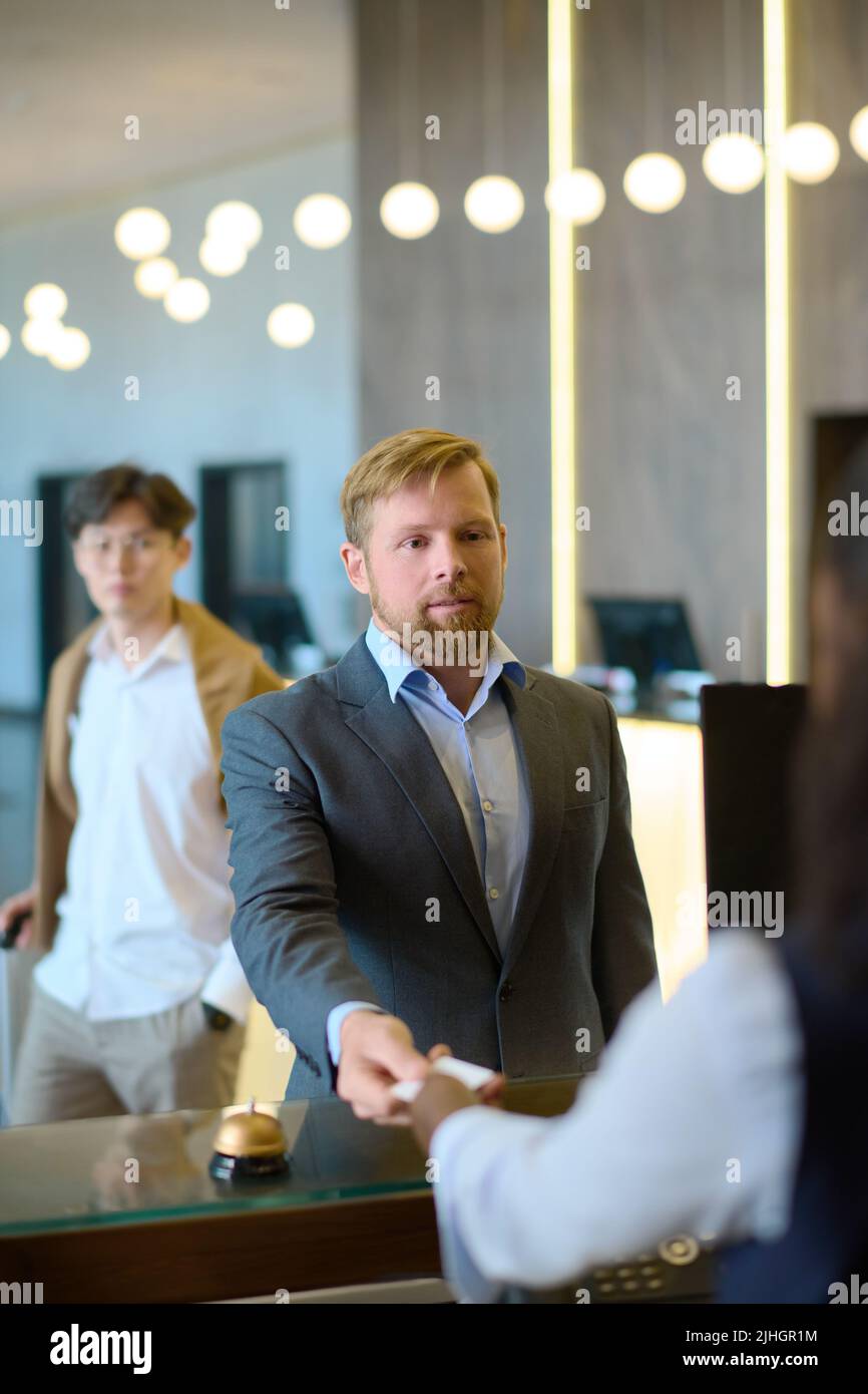 Receptionist standing in hotel lobby hi-res stock photography and ...