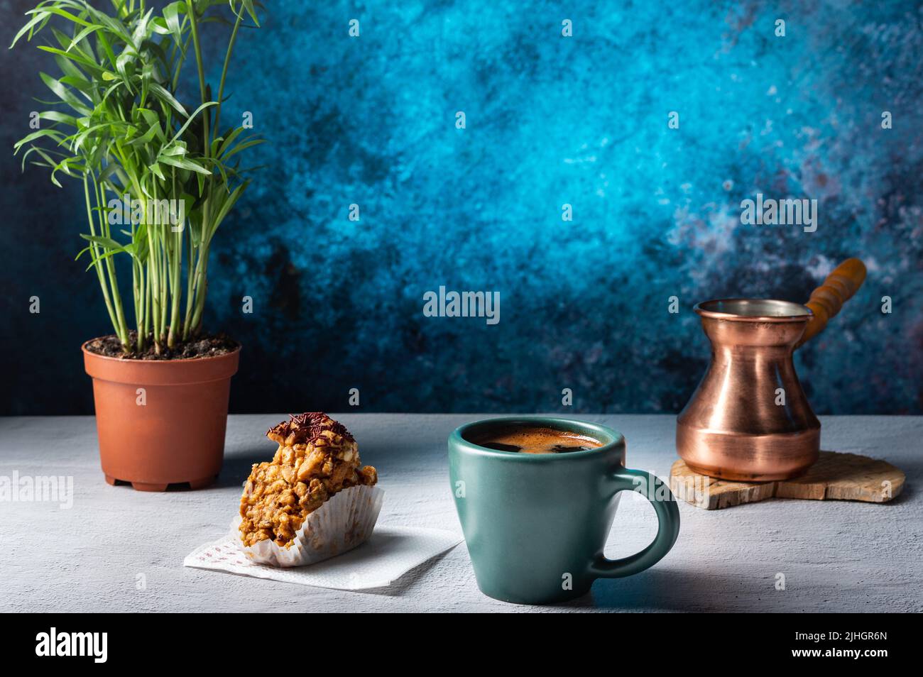 Black coffee is brewed in a copper cezve. Coffee and nut sweets. Coffee ...