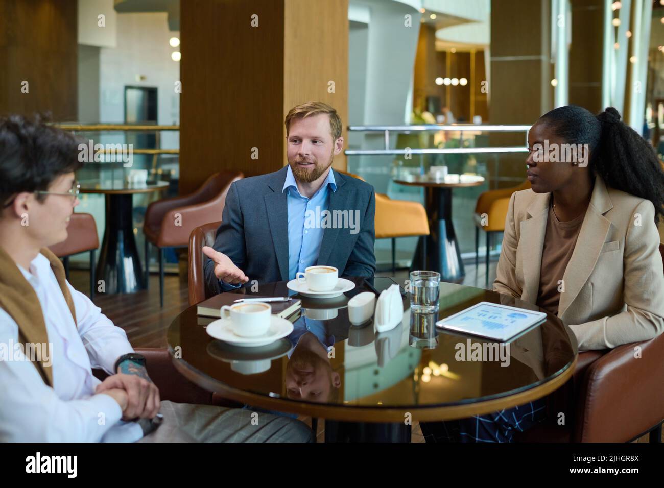 Hotel guest sitting in lounge hi-res stock photography and images - Alamy
