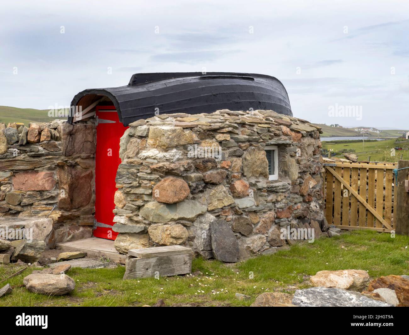 A shed using an old boat as a roof in Houss on East Burra, Shetland ...