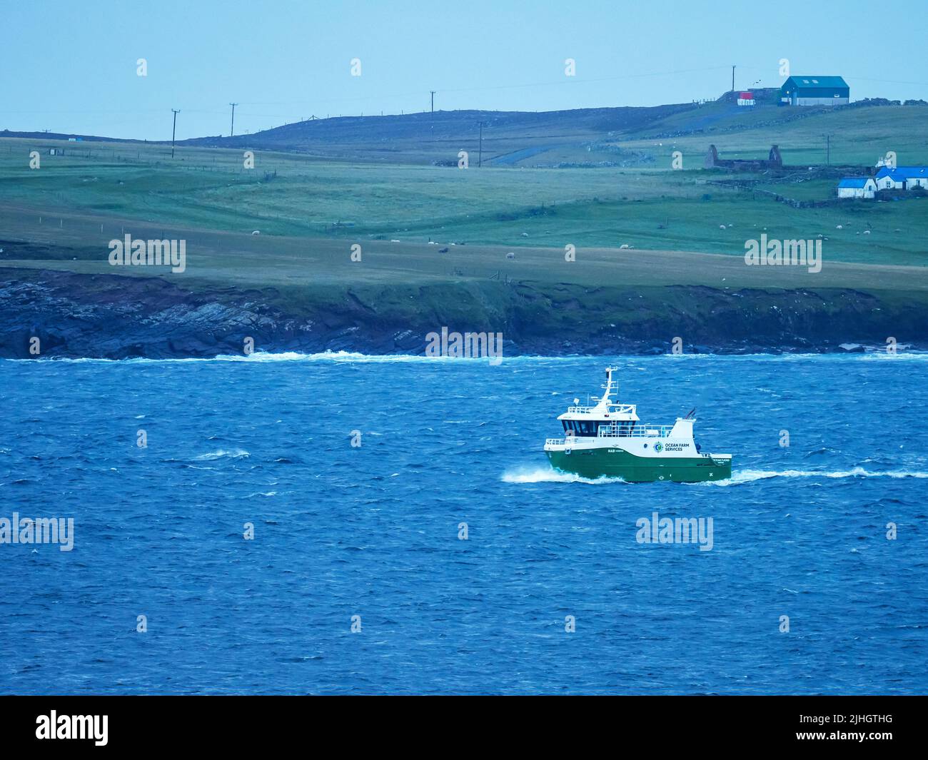 A fish farm service vessel crossin infornt of Papa Stour, Shetland ...