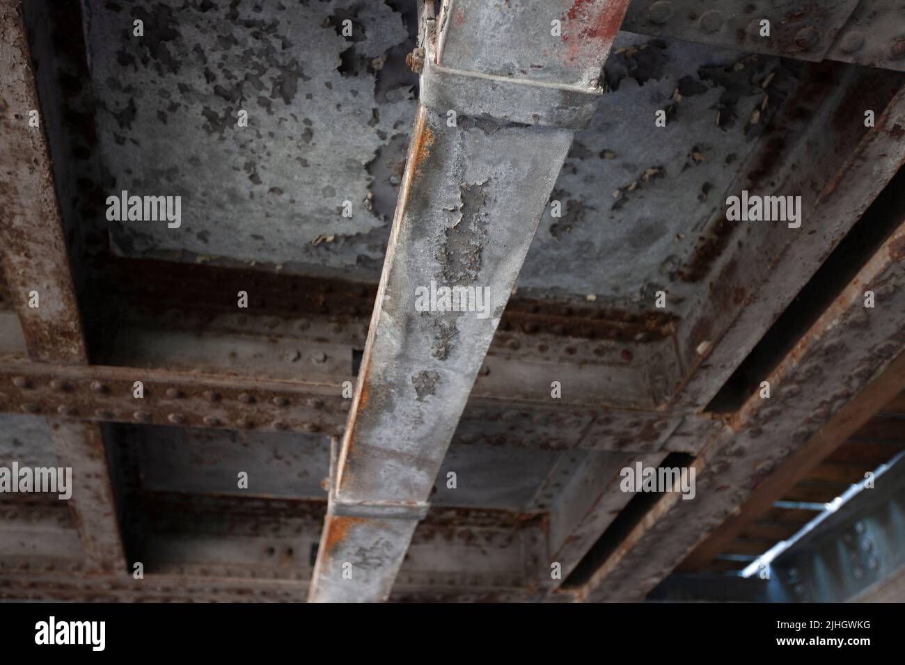 Aging infrastructure. A rusty and aging underside of a metal bridge ...
