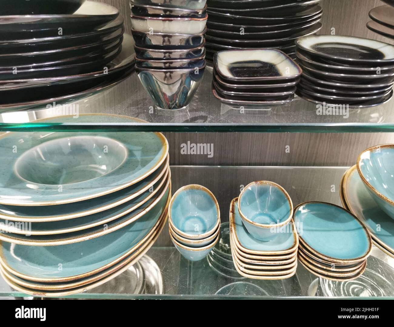 Stacks of tableware in a shop Stock Photo - Alamy