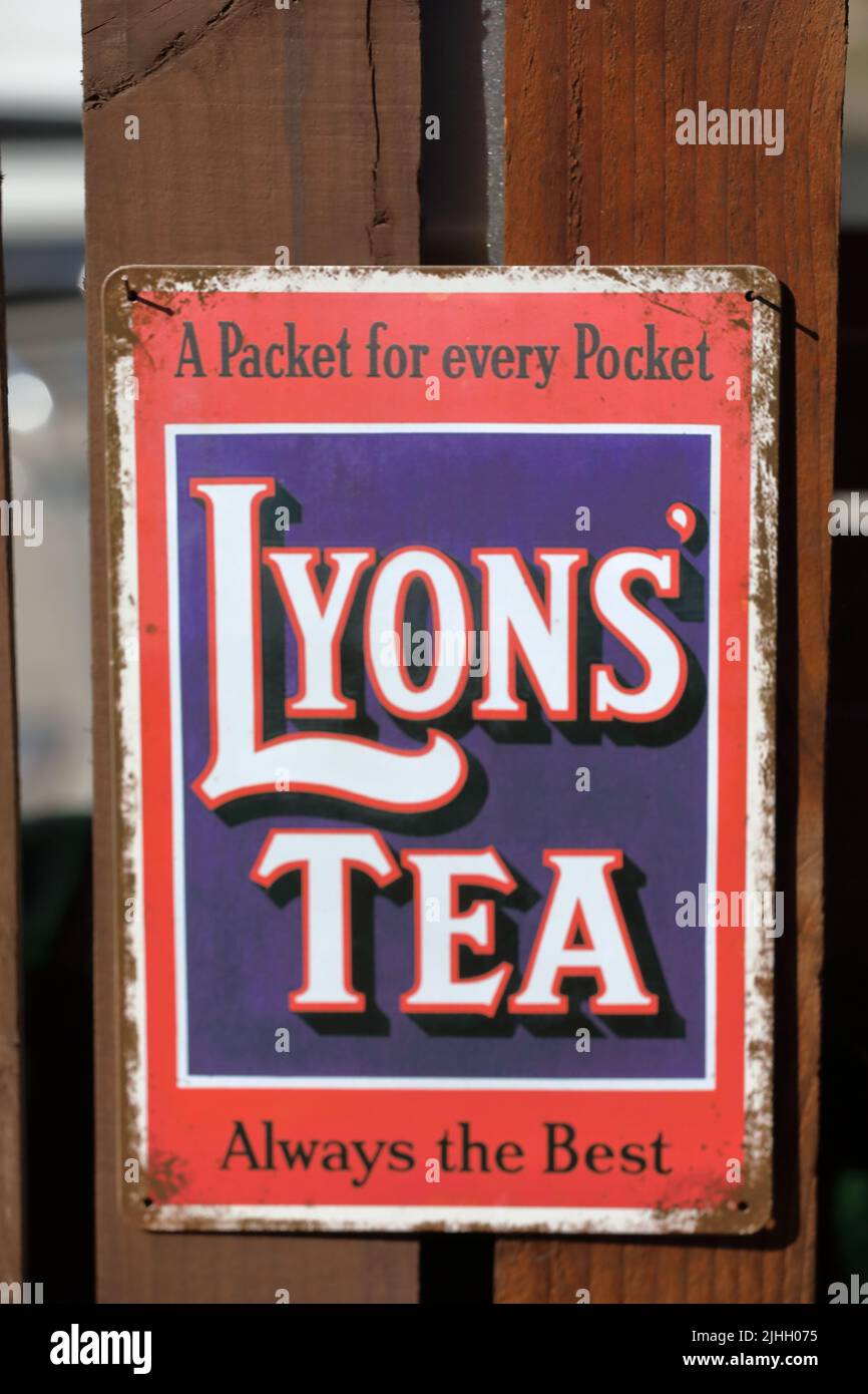 an oldish looking metal lyons' tea advertising wall sign Stock Photo ...