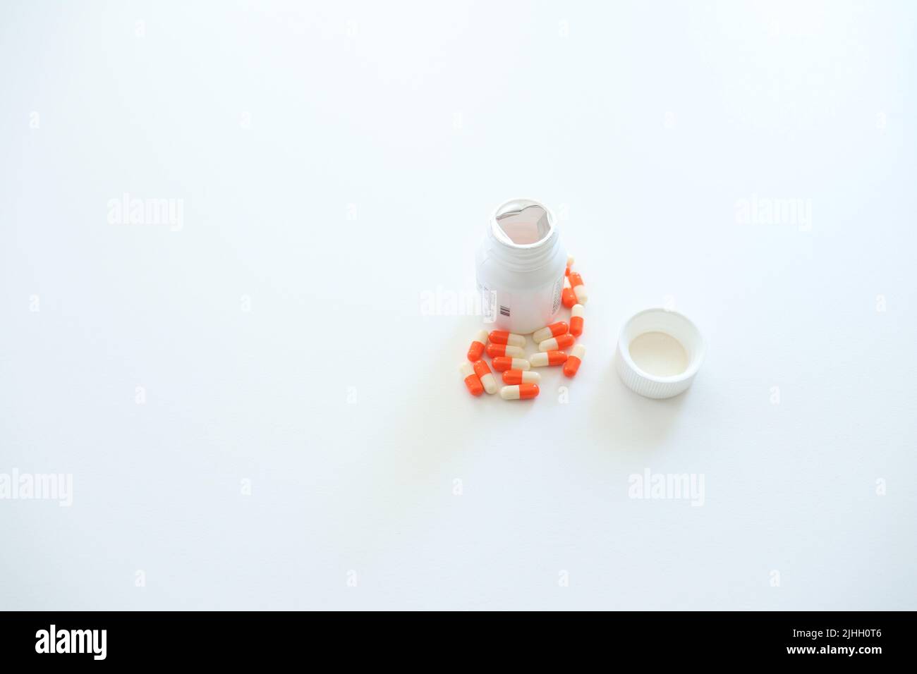 Medicine box and pills isolated on white background. spilled orange ...