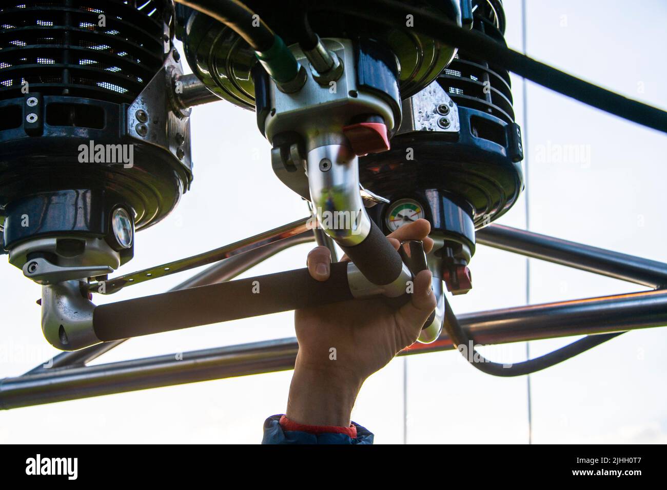 Detail view of a hand controlling the pressure of the gas valve Stock ...