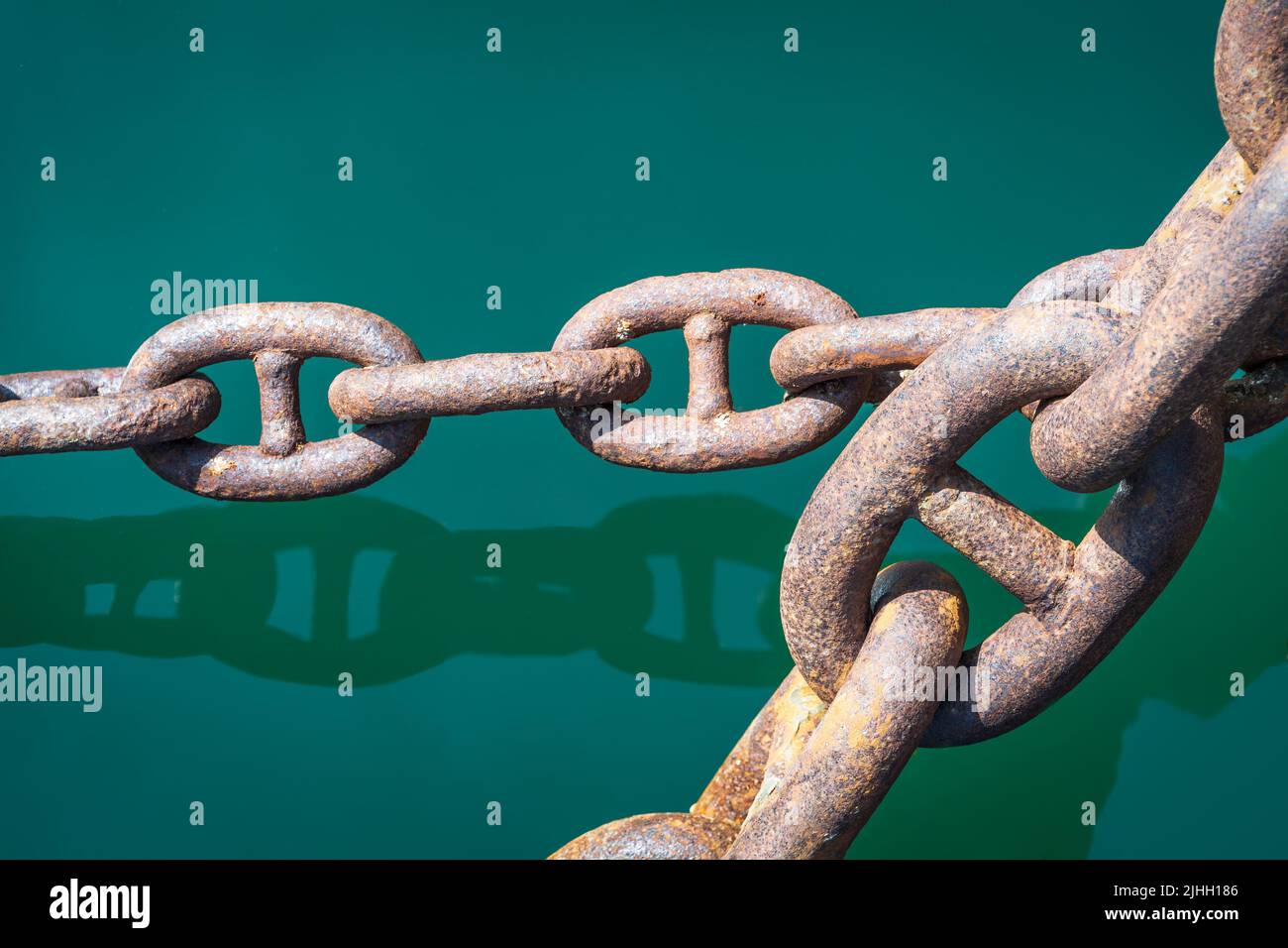 Detail of large ship's anchor chain midway between the vessel's bow and ...