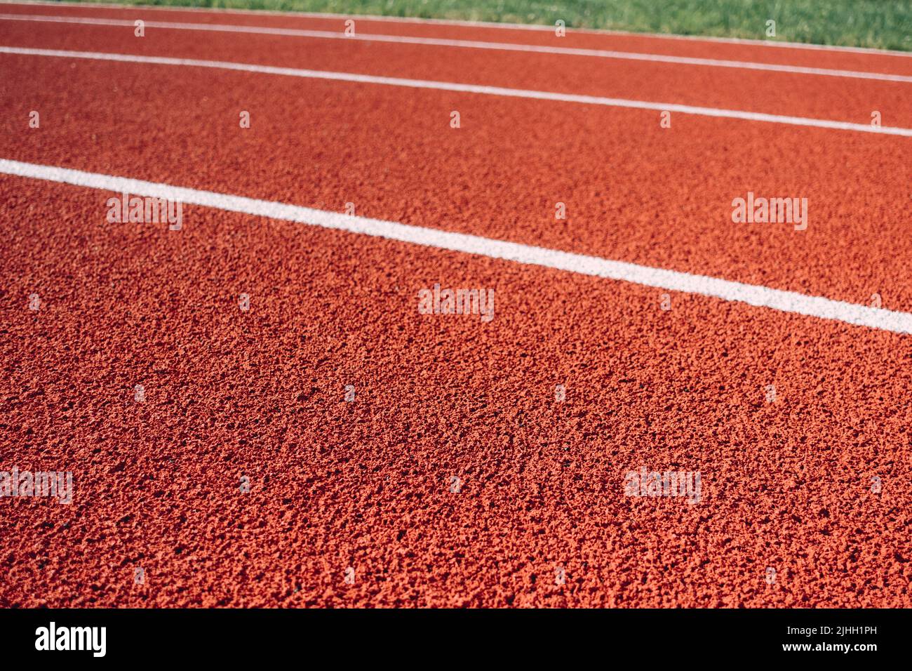 Sports stadium with red artificial rubber ground running tracks and ...
