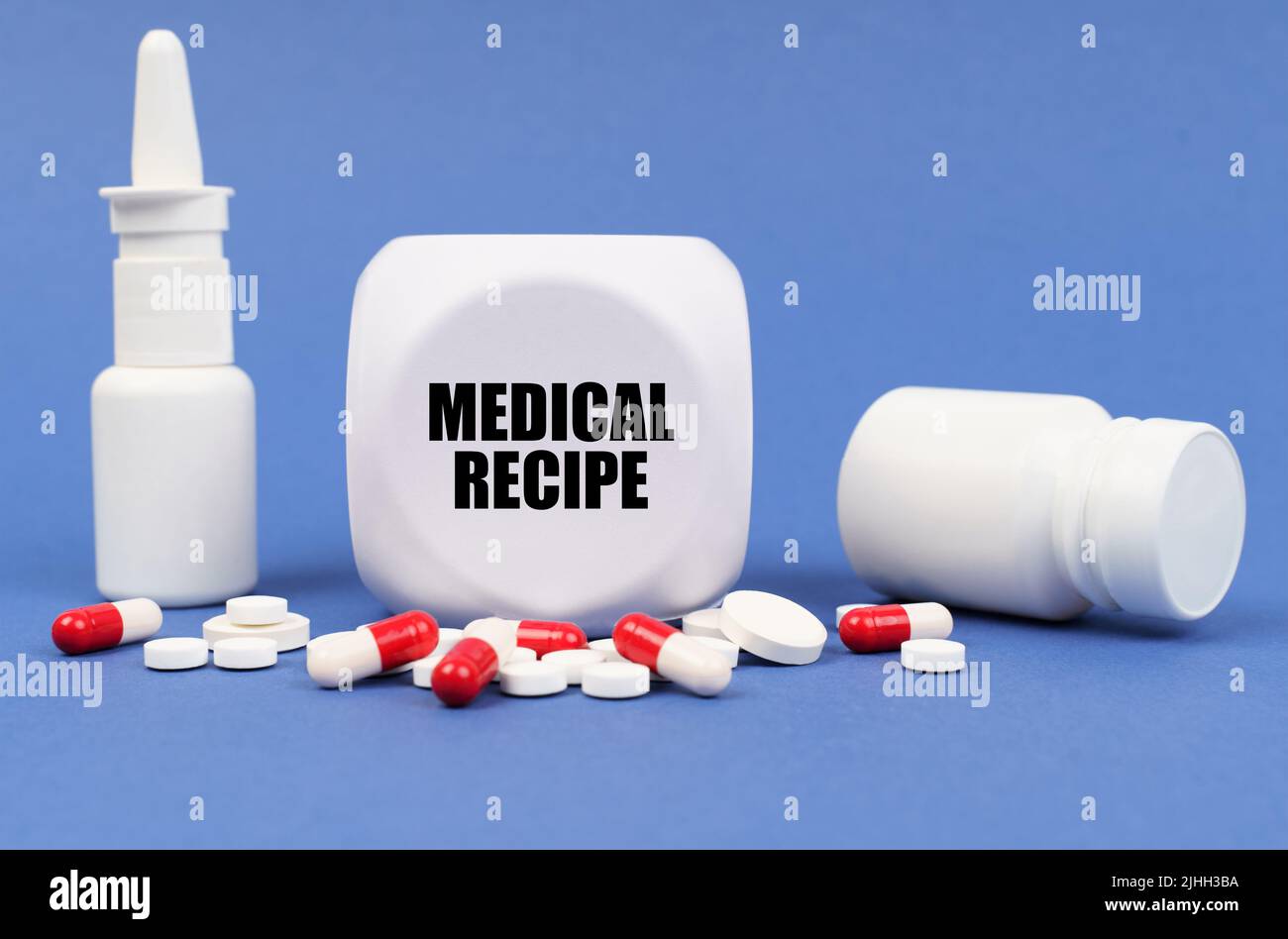 Medical concept. On the blue surface of the pill, capsule, spray, jar ...