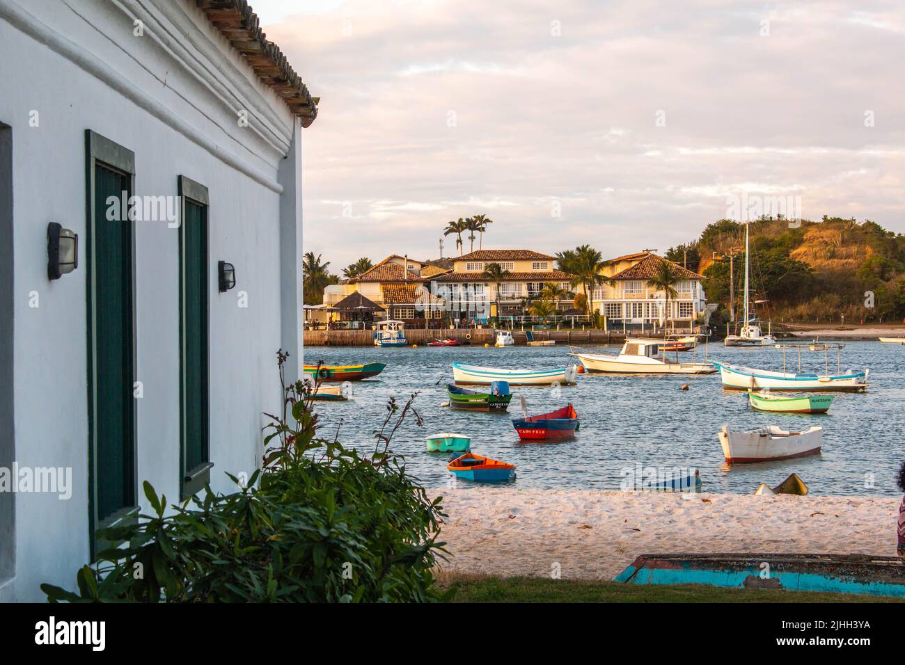 Typical colonial house next to the beach with small fishing boats, in ...