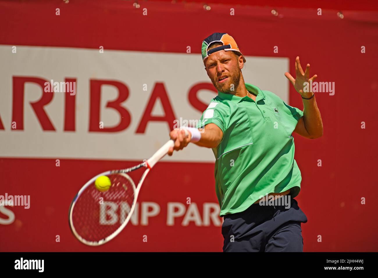 French tennis player Hugo Grenier hits a forehand in his match versus ...