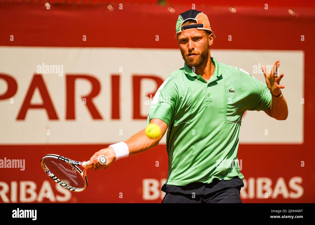 French tennis player Hugo Grenier hits a forehand in his match versus ...