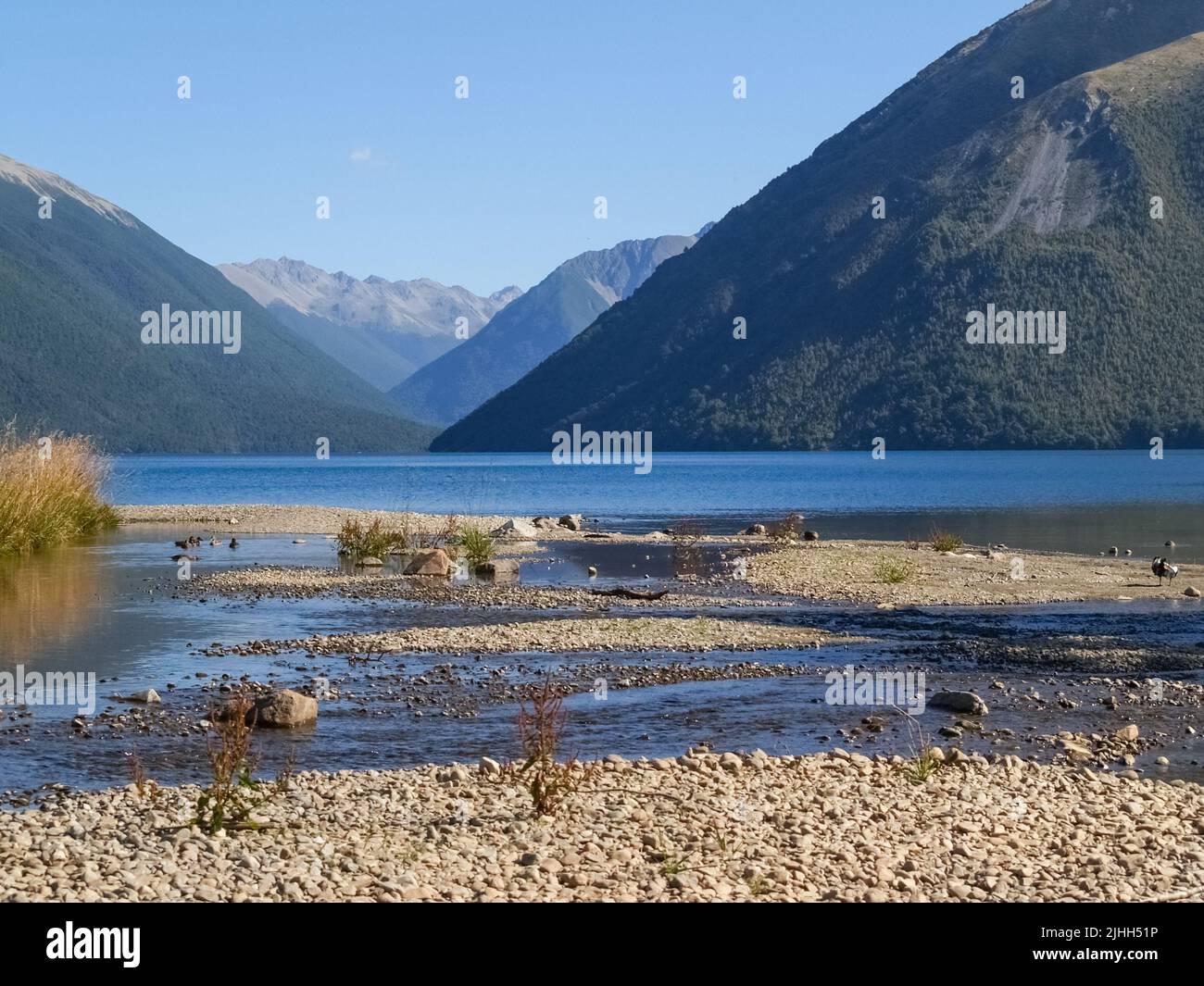 Scenic lake edge with dramatic mountain background Stock Photo - Alamy