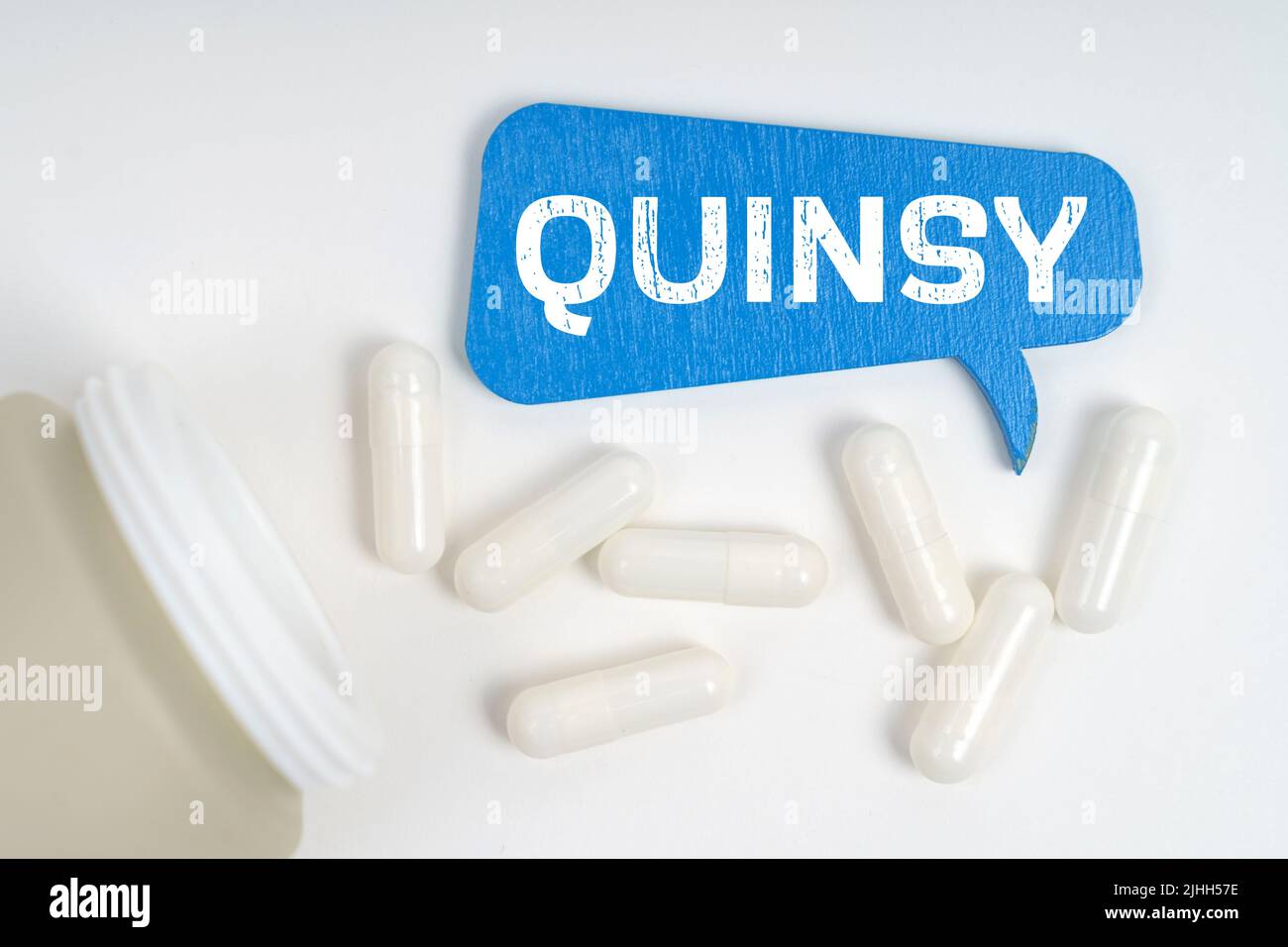 Medicine and health concept. On the table are pills and a blue sign ...