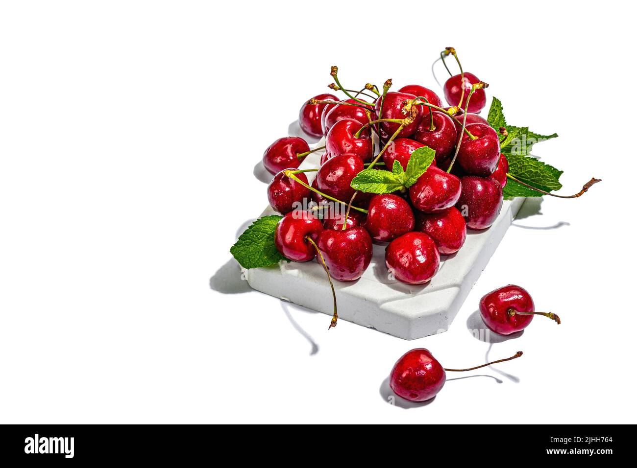 Ripe sweet cherries with fresh mint leaves isolated on white background ...