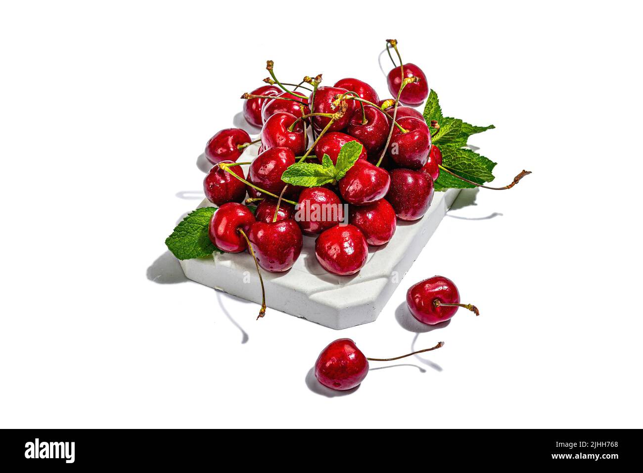 Ripe sweet cherries with fresh mint leaves isolated on white background ...