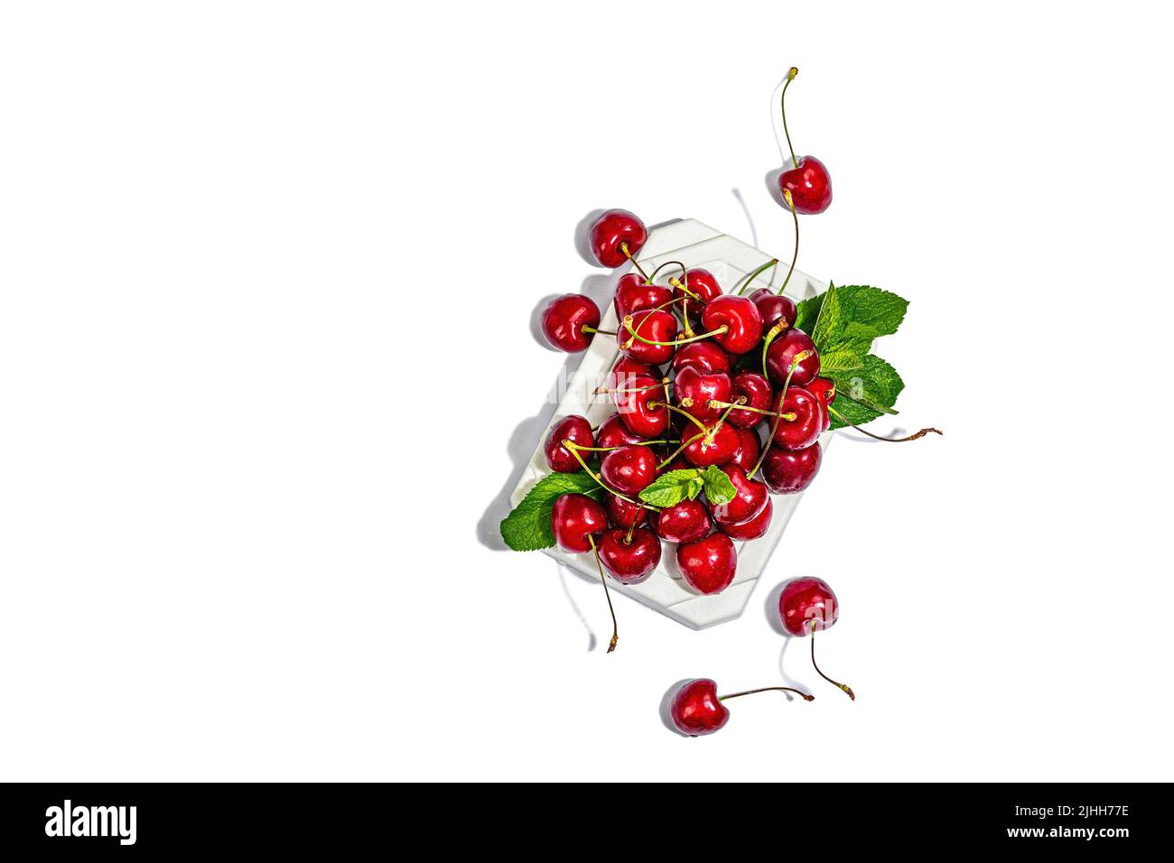 Ripe sweet cherries with fresh mint leaves isolated on white background ...