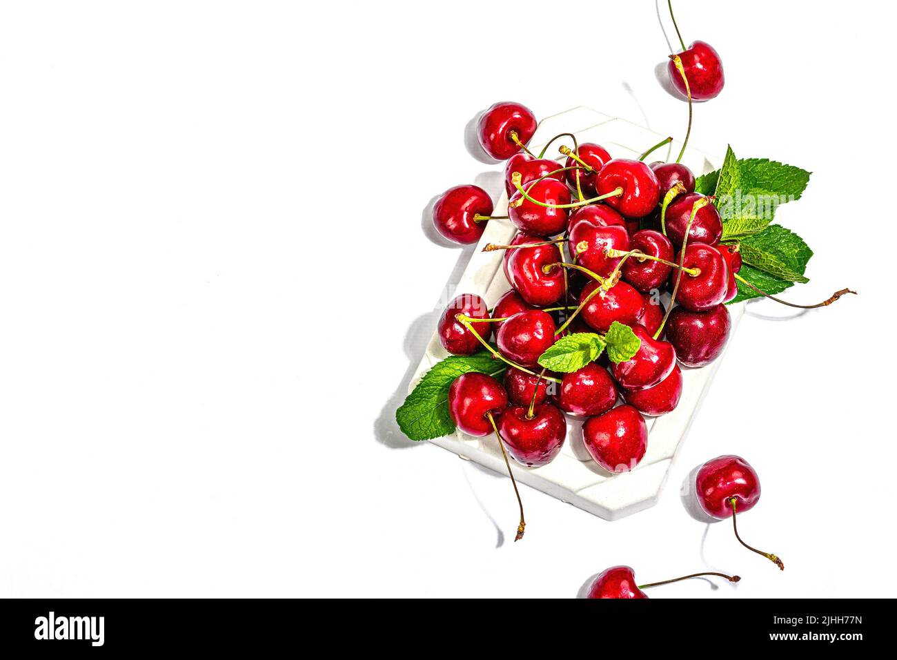 Ripe sweet cherries with fresh mint leaves isolated on white background ...