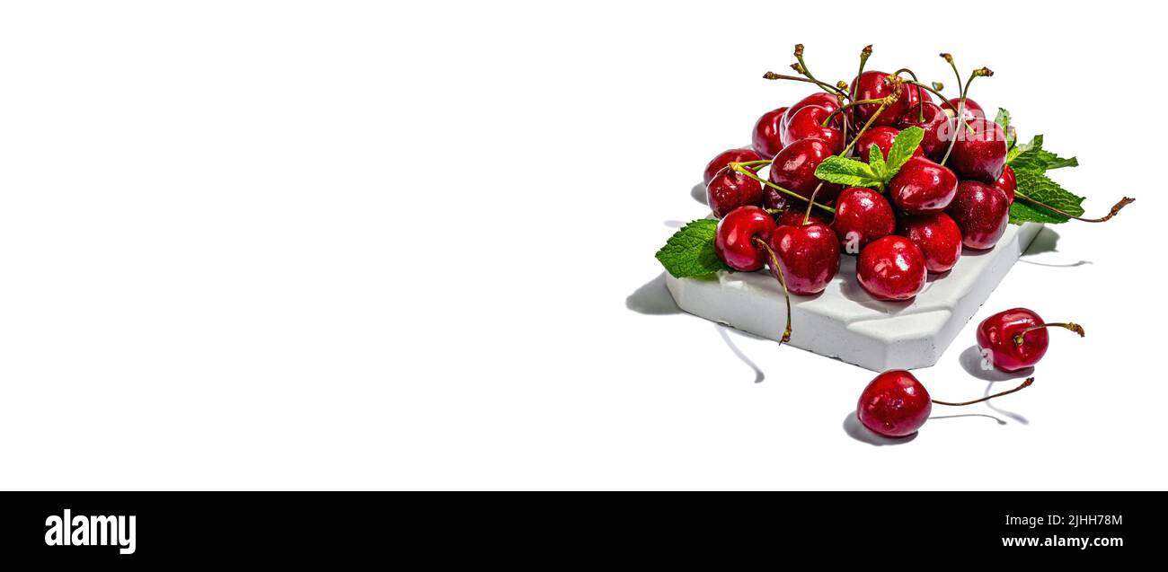 Ripe sweet cherries with fresh mint leaves isolated on white background ...